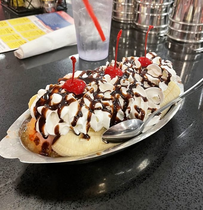 Not just a banana split—it's a mountain of joy with whipped cream peaks, chocolate rivers, and cherry-topped summits that demand to be conquered. 