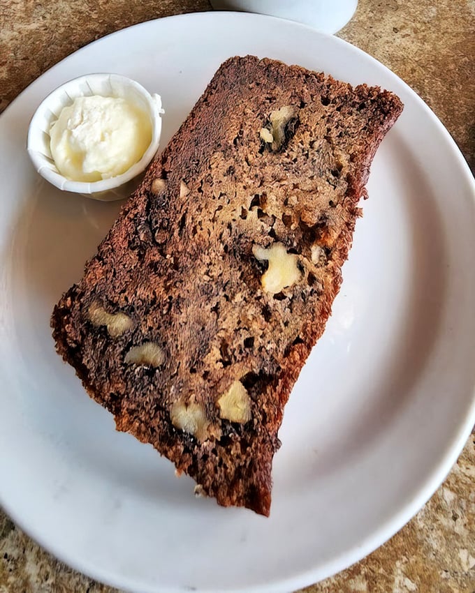 Banana walnut bread that would make your grandmother both proud and jealous. The butter cup isn't optional—it's essential to the experience.