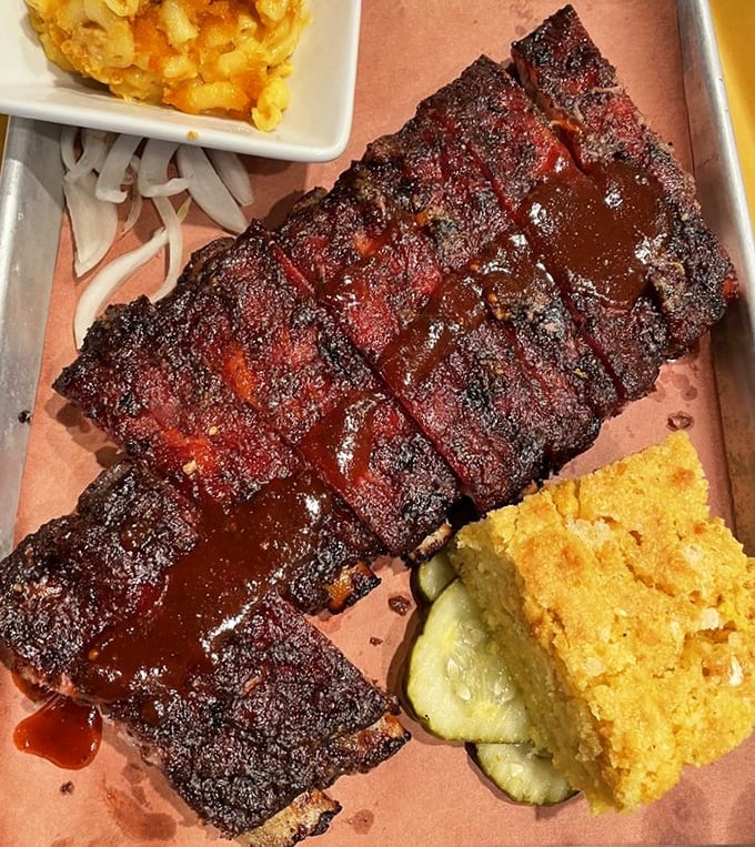 These ribs don't just fall off the bone—they practically leap into your mouth, their smoke ring a badge of honor earned through hours of patient cooking.