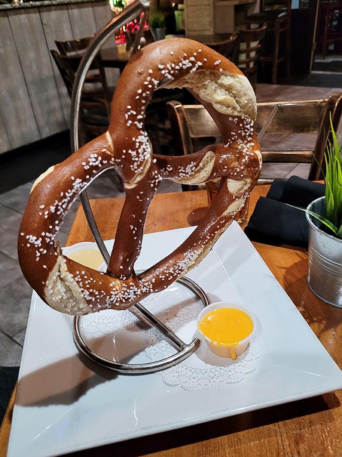 The Bavarian pretzel arrives like edible architecture—a twisted monument to the simple joy of dough, salt, and whatever that heavenly dipping sauce might be.