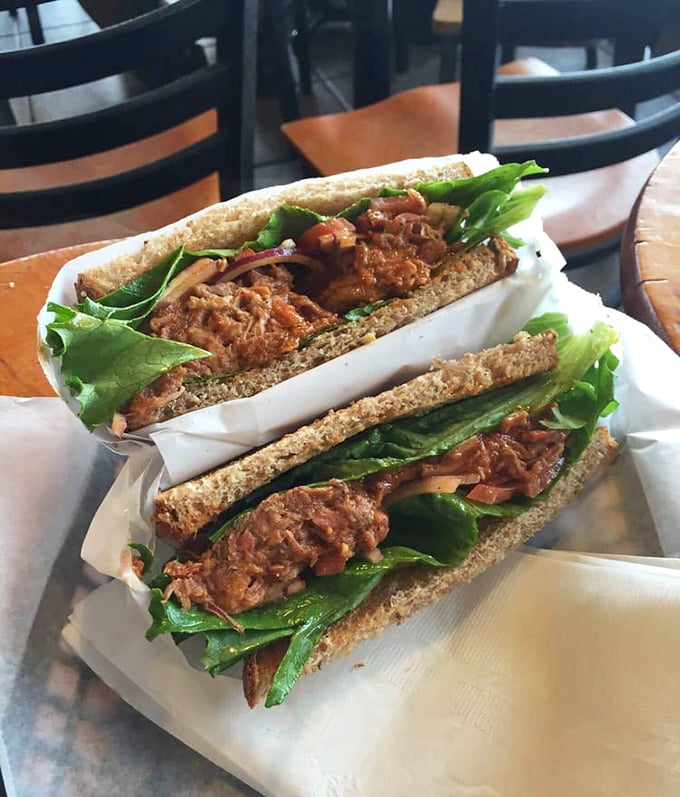 This BBQ pulled pork sandwich isn't just lunch—it's edible architecture, with layers of tender meat and crisp greens between sturdy bread foundations.