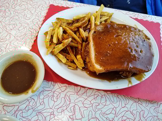 Hot roast beef sandwich swimming in gravy—comfort food that hugs you from the inside. Those hand-cut fries aren't just sides, they're gravy delivery vehicles.