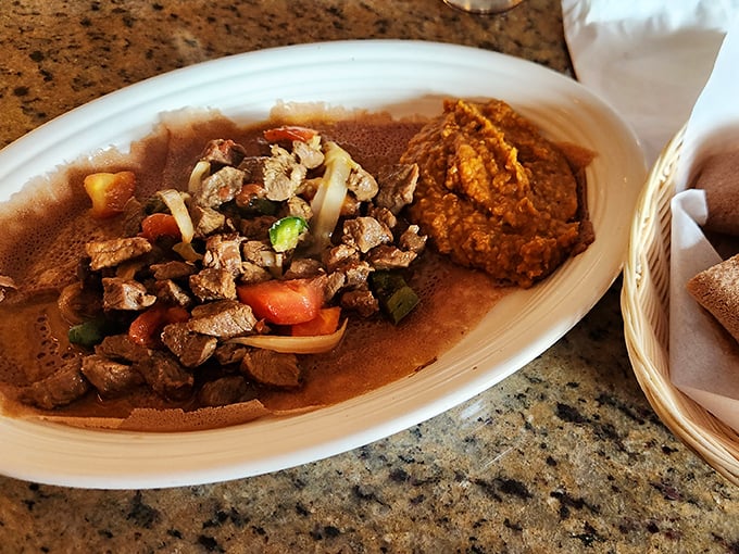 Beef Tibs—where tender meat meets vibrant vegetables on a bed of injera. This isn't just dinner; it's a tactile adventure for your hands and palate.