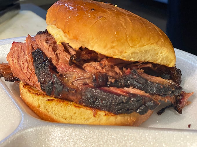 This isn't just a sandwich; it's a masterclass in smoke and patience—brisket so tender it practically surrenders to your bite.