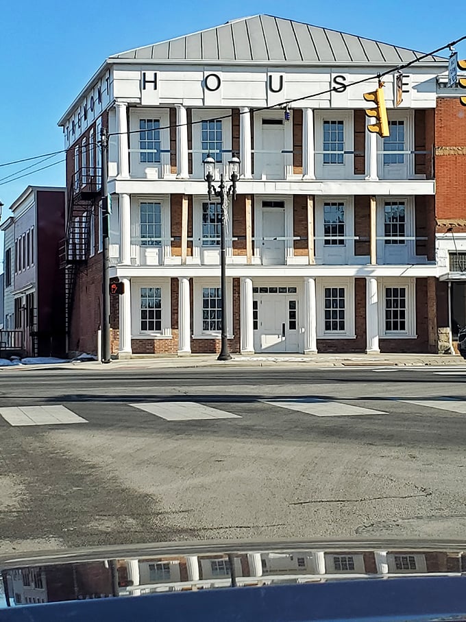 The "HOUSE" building isn't just another pretty facade—it's three stories of history with a front-row seat to Bellevue's daily parade of life.