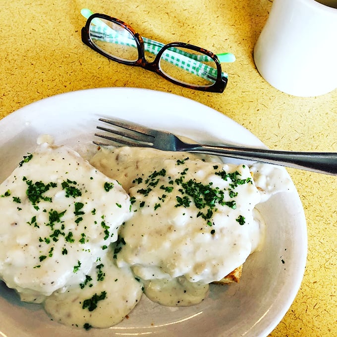 These biscuits and gravy aren't just a meal—they're an experience. Creamy, herb-flecked gravy cascading over pillowy biscuits like a comfort food waterfall.
