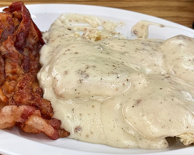 Biscuits and gravy with a side of perfectly crisped bacon – the kind of breakfast that makes you understand why people write songs about coming home.