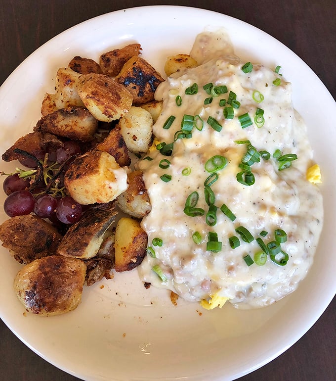 This isn't just breakfast; it's edible therapy. Creamy biscuits and gravy with perfectly roasted potatoes that could solve most of life's problems.