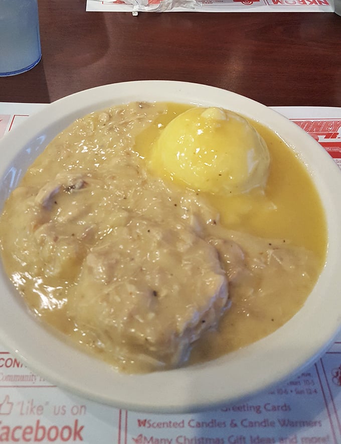 Hot roast beef swimming in rich gravy alongside a golden-topped baked potato—comfort food that hugs your soul on a plate.