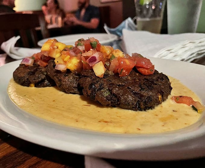 Black bean cakes topped with vibrant mango salsa – proof that vegetarian dishes can make even dedicated carnivores forget to ask, "Where's the beef?"