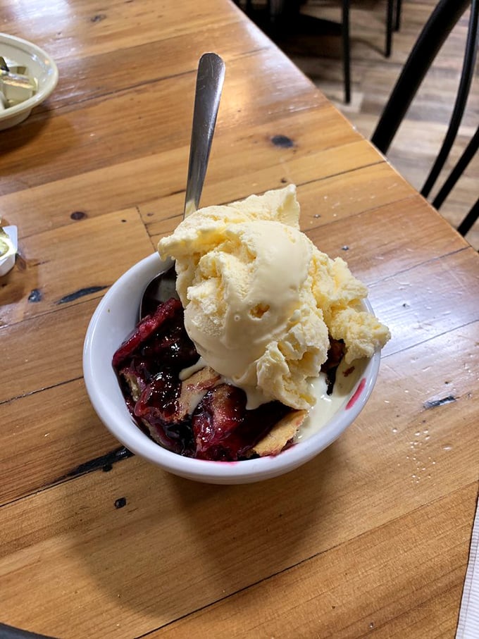 The blackberry cobbler arrives with a scoop of vanilla ice cream melting into the warm fruit below – a sweet symphony that hits all the right notes.