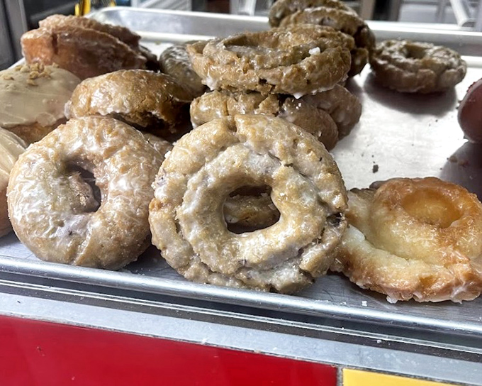 Old-fashioned donuts with their characteristic cracks and crevices—nature's way of creating more surface area for glaze. Engineering and deliciousness in one package.