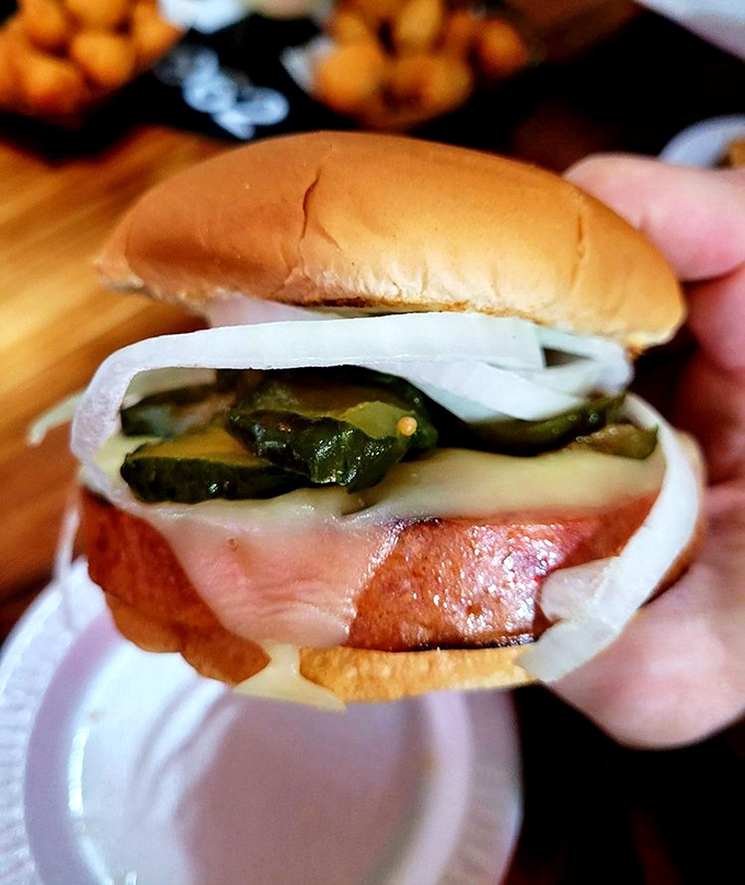 The famous bologna sandwich in all its glory—thick-cut, perfectly fried, with pickles and onions. Childhood lunch, all grown up and magnificent.