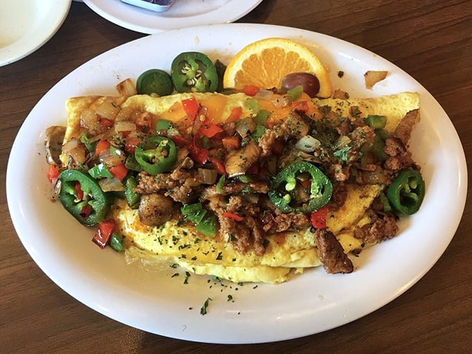 This isn't just an omelet—it's a flavor explosion with jalapeños standing guard like spicy sentinels over a kingdom of chorizo and cheese.