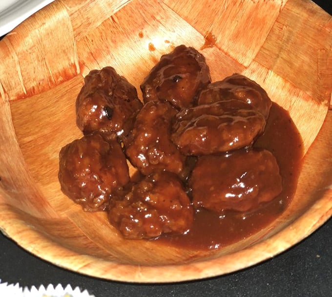 These aren't just wings—they're glistening flavor bombs swimming in sauce that demands to be licked from fingers, napkins be damned.