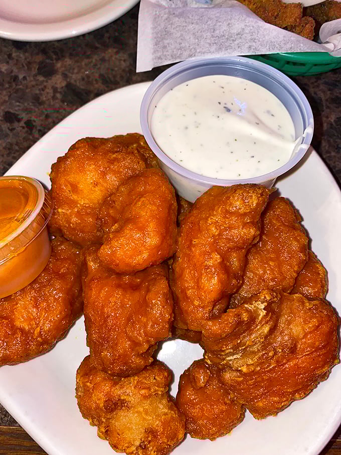 These golden-brown boneless wings aren't just fried—they're transformed into crunchy vessels of joy, waiting for their dipping sauce destiny.