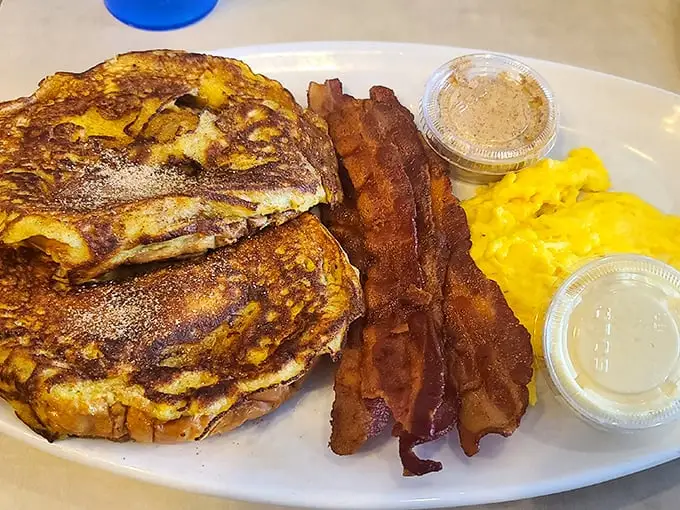 French toast that's achieved that mythical balance—crispy exterior, custardy interior—paired with bacon cooked exactly how bacon should be.