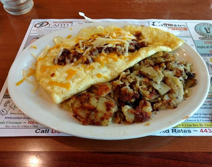 Breakfast doesn’t get better than a fluffy omelet that’s more than folded eggs—it’s culinary creativity on a plate, paired with home fries worthy of stealing the spotlight.