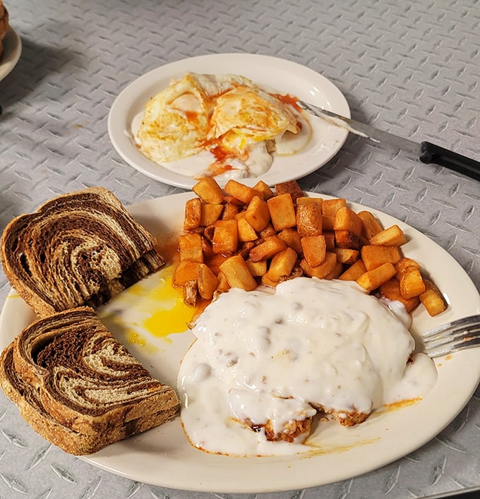 Marbled rye toast, perfectly cooked eggs, and home fries that could make a potato proud to have sacrificed itself for such a noble cause.
