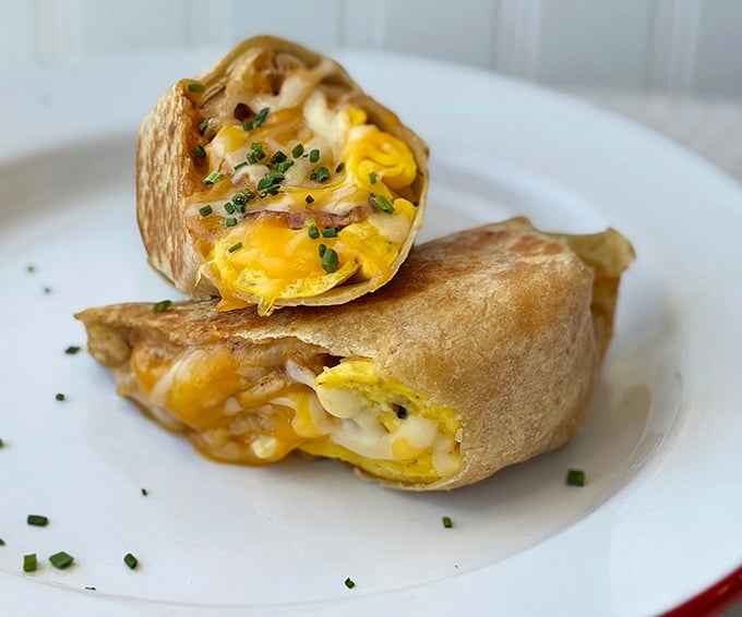 Breakfast burritos here aren't just morning fuel—they're wrapped treasures of eggs, cheese and potential happiness, garnished with fresh chives.