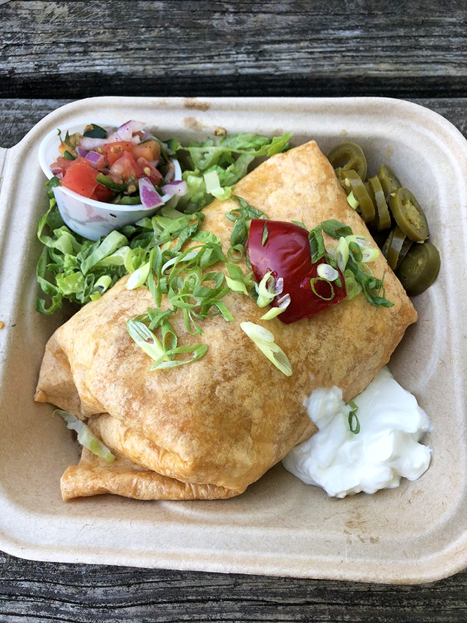 This isn't just a breakfast burrito—it's a perfectly wrapped present to yourself, complete with fresh salsa that tastes like someone's grandmother made it.