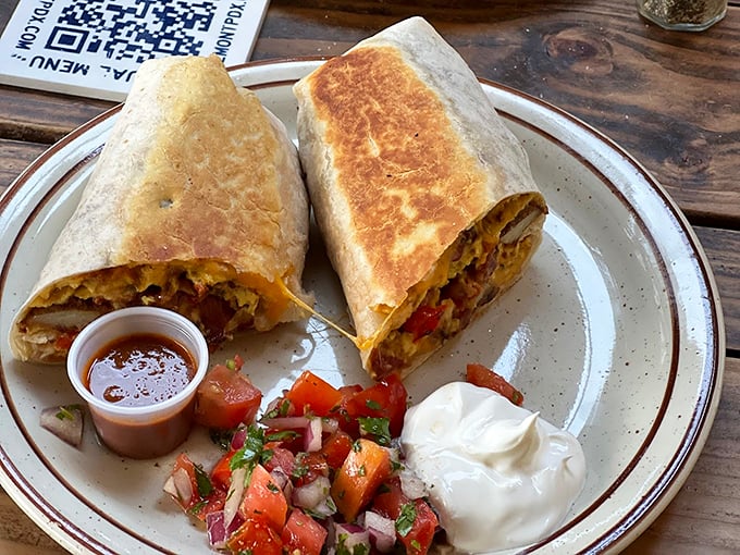 This breakfast burrito isn't messing around—packed tight with morning goodness and flanked by fresh pico de gallo that brightens every bite.