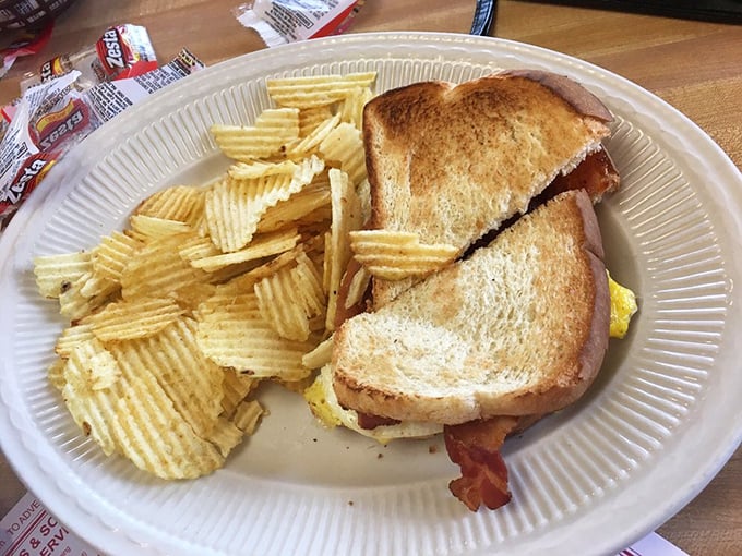 This isn't just a breakfast sandwich; it's morning architecture – golden toast, crispy bacon, and eggs, with potato chips standing guard.
