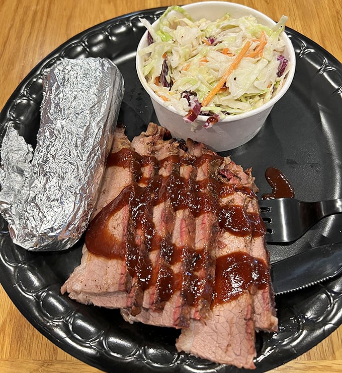 Brisket so tender it practically surrenders at the sight of your fork. The BBQ trinity of meat, slaw, and beans in perfect harmony.