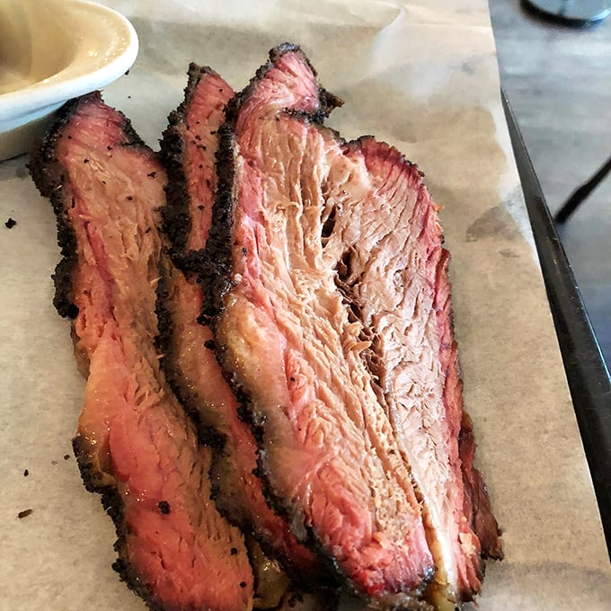 Brisket with that perfect pink smoke ring isn't just meat—it's edible evidence of patience, skill, and barbecue devotion that transcends state lines.