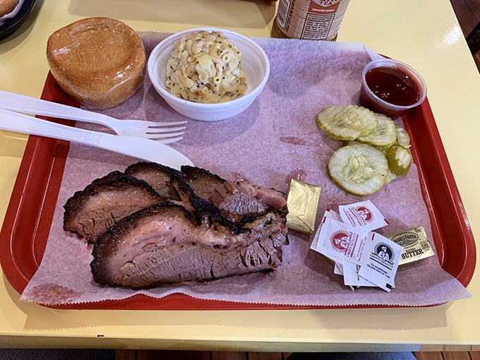 Brisket that would make a Texan weep with joy, complete with that coveted pink smoke ring. The pickles aren't just garnish—they're the perfect acidic counterpoint. 