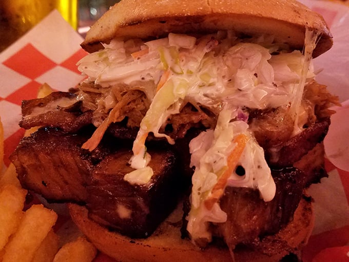 The brisket sandwich—where smoked beef meets cool slaw in perfect harmony. It requires a firm grip and zero shame about the sauce that will inevitably decorate your face.