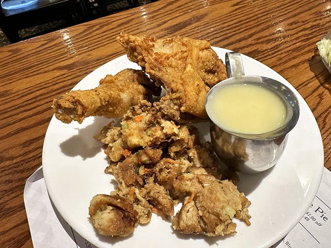 Fried chicken that's worth crossing roads for, served with a side of gravy that could make cardboard taste magnificent. This isn't diet food—it's joy food.
