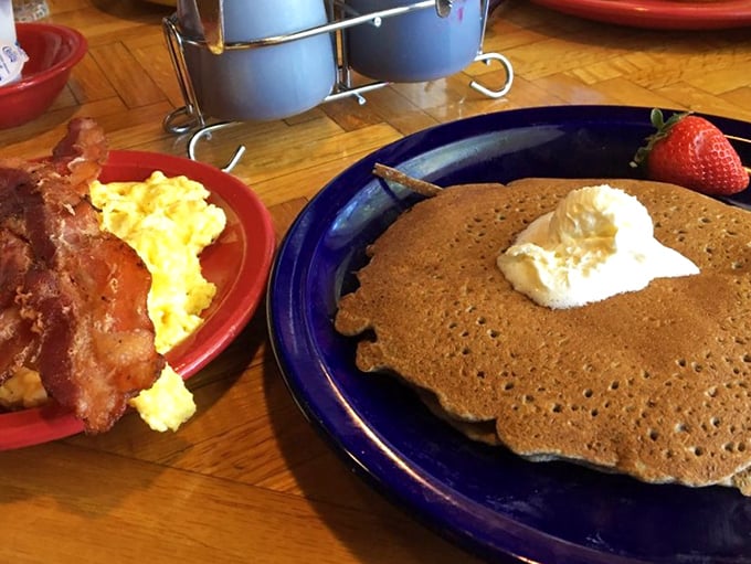 Golden-brown buckwheat pancakes with a dollop of butter and crispy bacon—proof that sometimes the simplest breakfast combinations are the most satisfying.