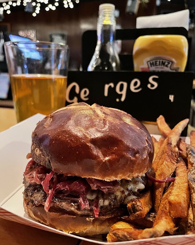 This isn't just a burger—it's architecture. The glossy bun, the melty cheese, the perfectly stacked ingredients—it's the Taj Mahal of tavern food. 