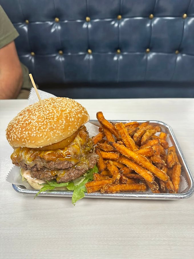 This isn't just a burger—it's architecture with cheese. The sesame seed bun crowns a masterpiece of beef and melty goodness.