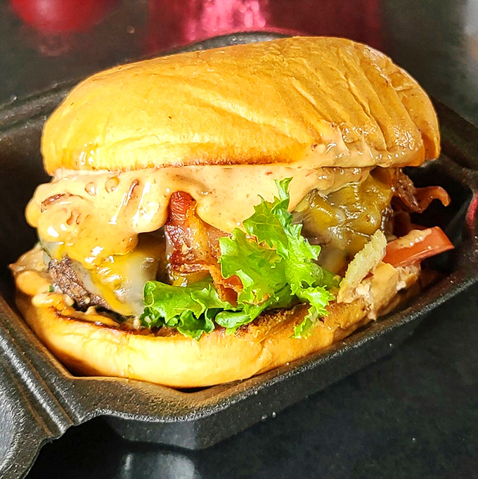 This burger doesn't just sit there looking pretty – it leans in with melty cheese, fresh greens, and a bun that's ready for its close-up.