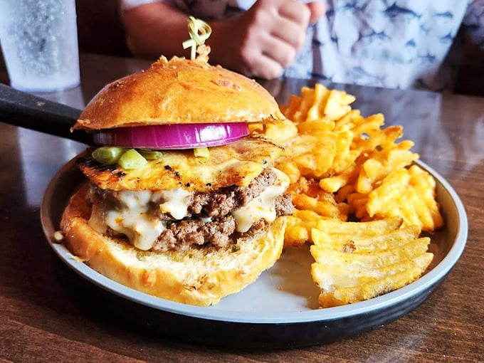 This isn't just a burger—it's architecture. Layers of beef, cheese, and toppings create a savory skyscraper that demands both admiration and a strategic eating plan.