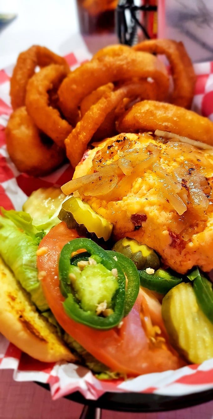 This isn't just a burger—it's architectural perfection. Golden onion rings stand guard while jalapeños add just enough kick to wake up your taste buds.