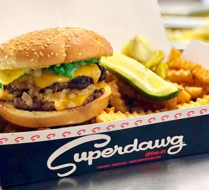 This isn't just a burger—it's a masterclass in American comfort food, complete with melty cheese, pickle sentinels, and fries that refuse to be mere sidekicks. 