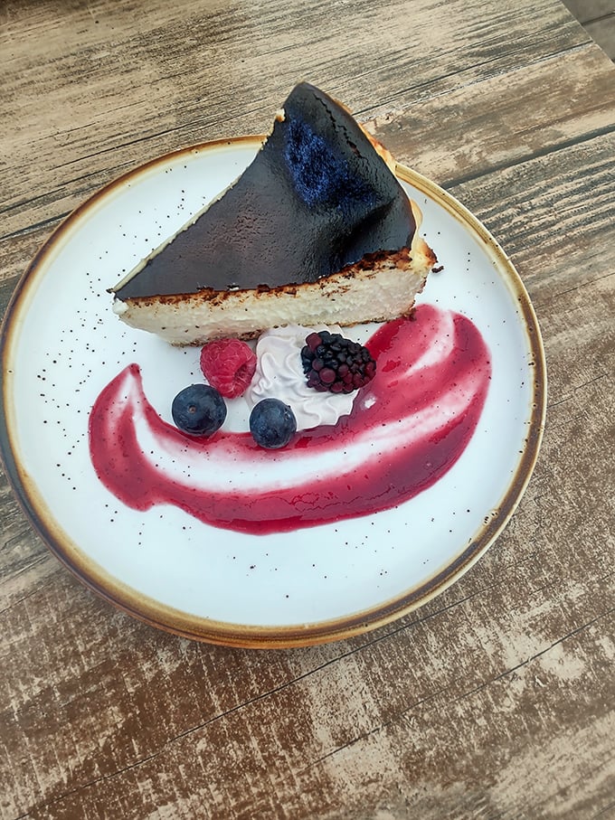 This Burnt Basque Cheesecake doesn't apologize for its dramatic appearance. The berry coulis swoop adds the perfect sweet-tart counterpoint.