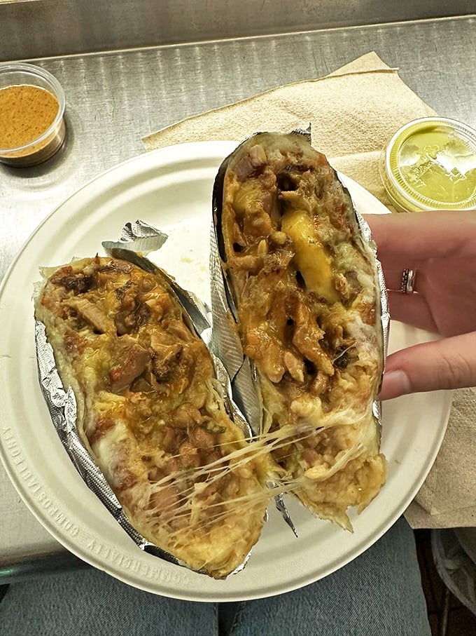 The burrito—a magnificent beast wrapped in foil, with cheese stretching like a suspension bridge between bites. Worth every napkin.