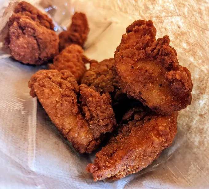 These golden-brown nuggets of Cajun catfish aren't just fried – they're transformed into crunchy bites of seafood heaven.