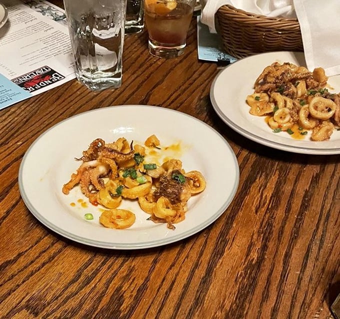 Calamari that would make coastal chefs jealous, tender rings dancing in a golden sauce that you'll be tempted to drink straight from the plate.