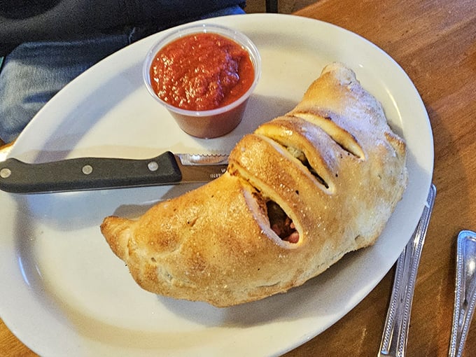 This calzone isn't just stuffed—it's having an existential crisis about containing so much deliciousness within its golden-brown, perfectly baked crust.