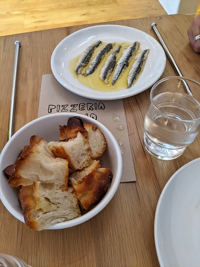 Cantabrian anchovies swimming in olive oil—the ocean's gift to your taste buds. Simplicity that speaks volumes about quality.