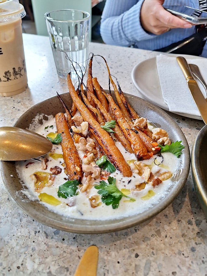 These aren't just roasted carrots; they're vegetable candy—sweet, earthy, and nestled in a creamy sauce that makes you question why vegetables ever needed a PR team.