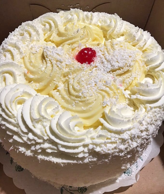 This isn't just cake—it's a cloud of buttercream perfection topped with a cherry that's practically winking at you.