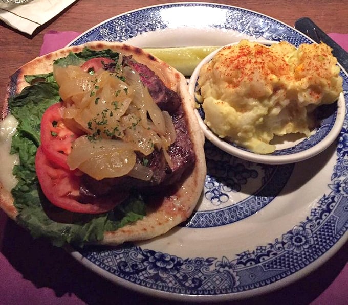The perfect marriage of beef and bread—this sandwich doesn't just satisfy hunger, it conquers it with caramelized onions and a side of creamy mashed potatoes.