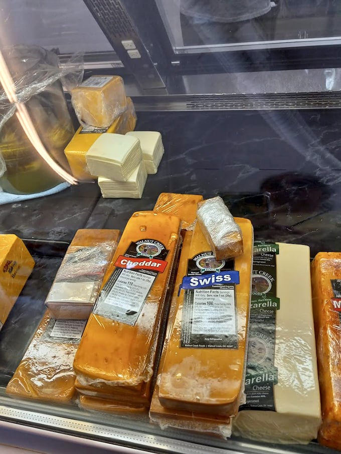 Blocks of golden goodness await their destiny – from Walnut Creek Swiss to sharp cheddar, this cheese case is where dreams begin.