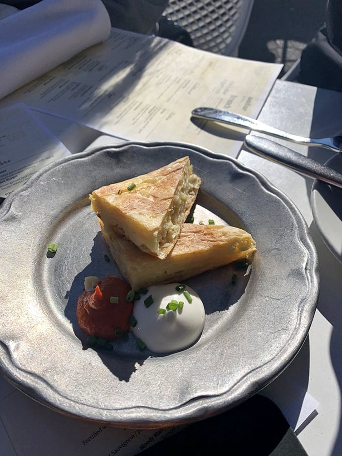 This cheese pie isn't just a snack—it's an education in Balkan comfort food. Flaky, cheesy, and paired with those two perfect dollops? Culinary poetry.
